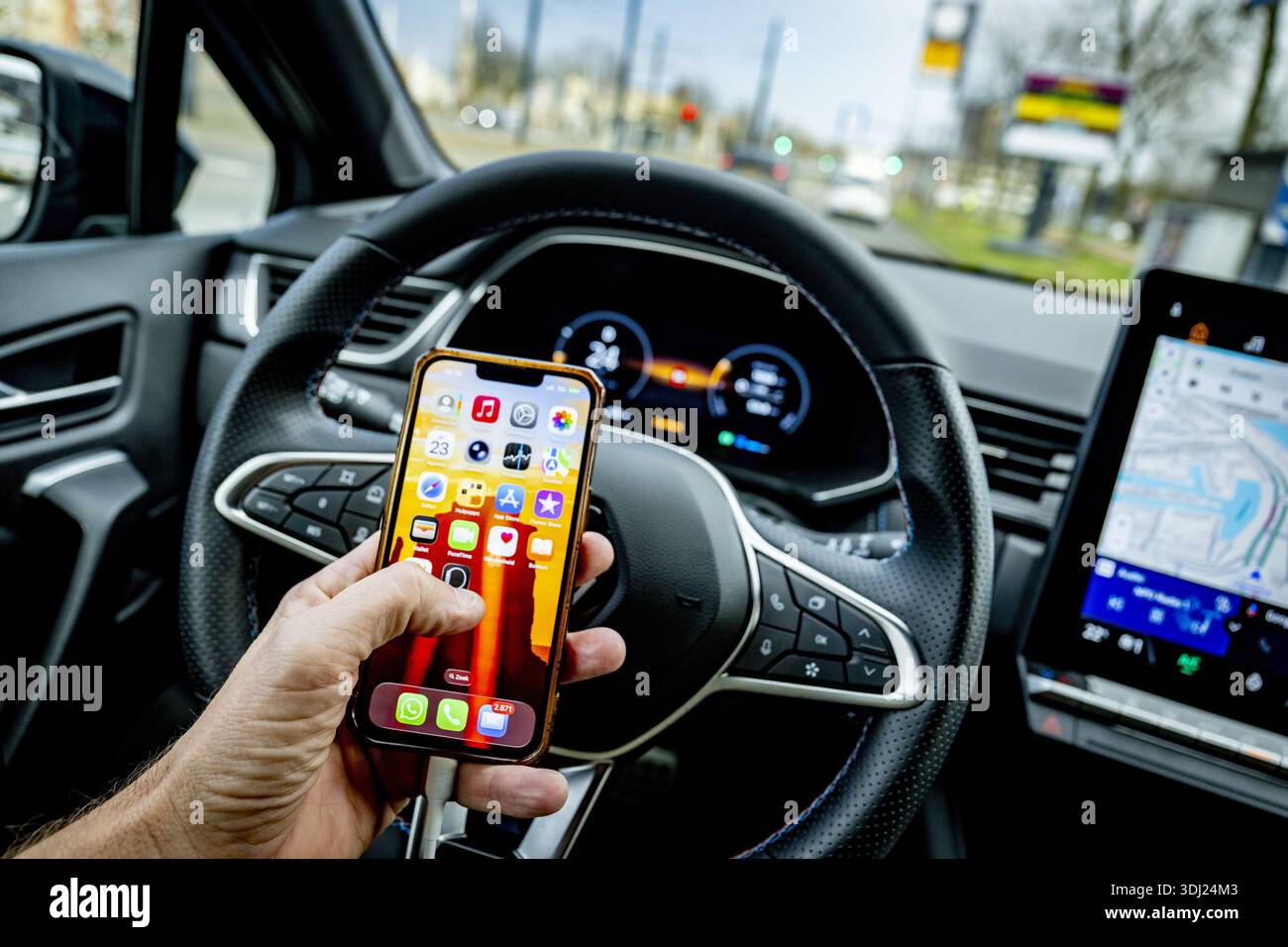 ILLUSTRATION - A man is using his phone while driving. ROBIN UTRECHT ...