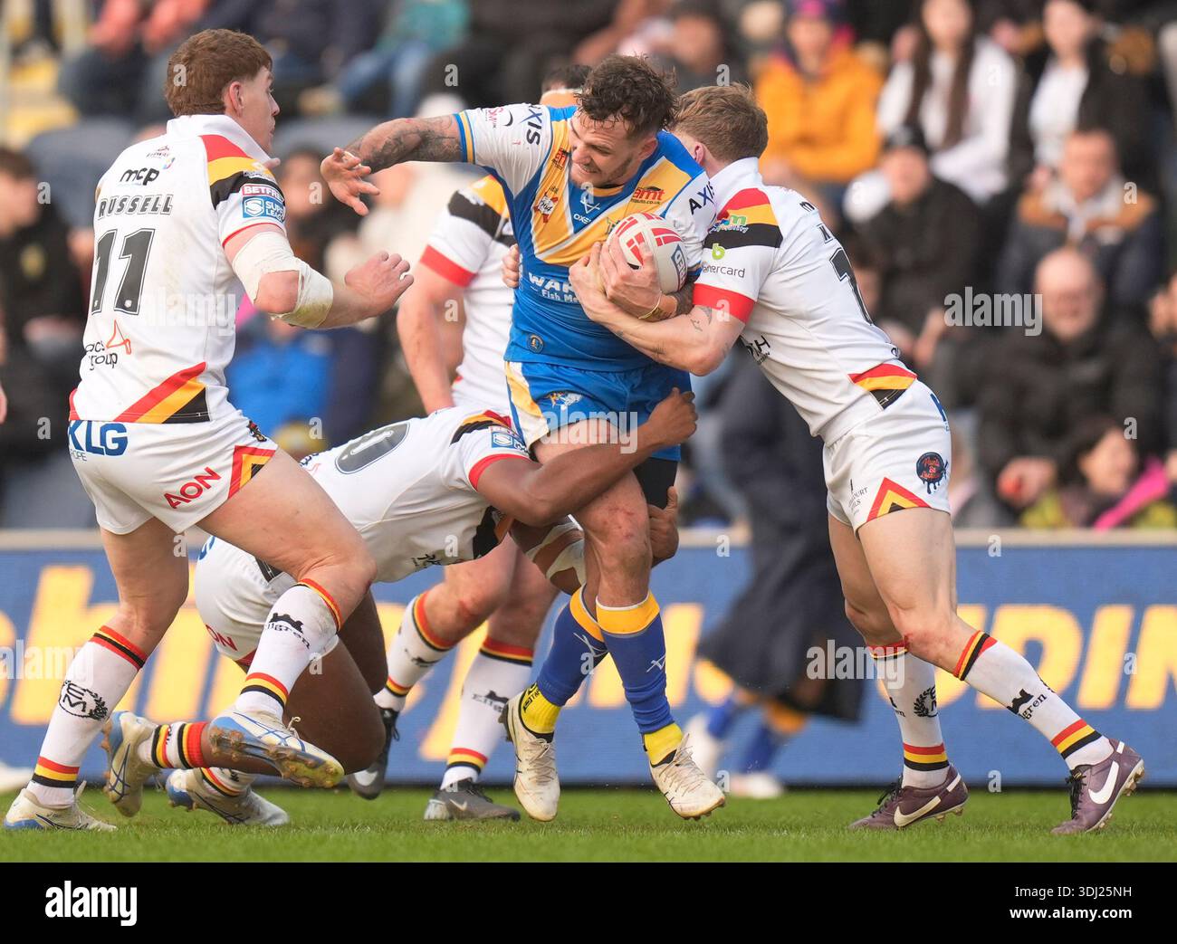 Leeds Rhinos' Ethan O'Neill is tackled by Bradford Bulls' Joe Keyes ...