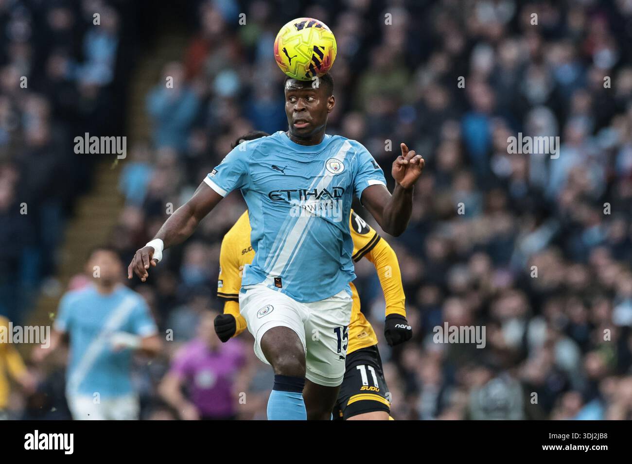 Marc Guehi of Manchester City jumps up to win the high ball during the ...