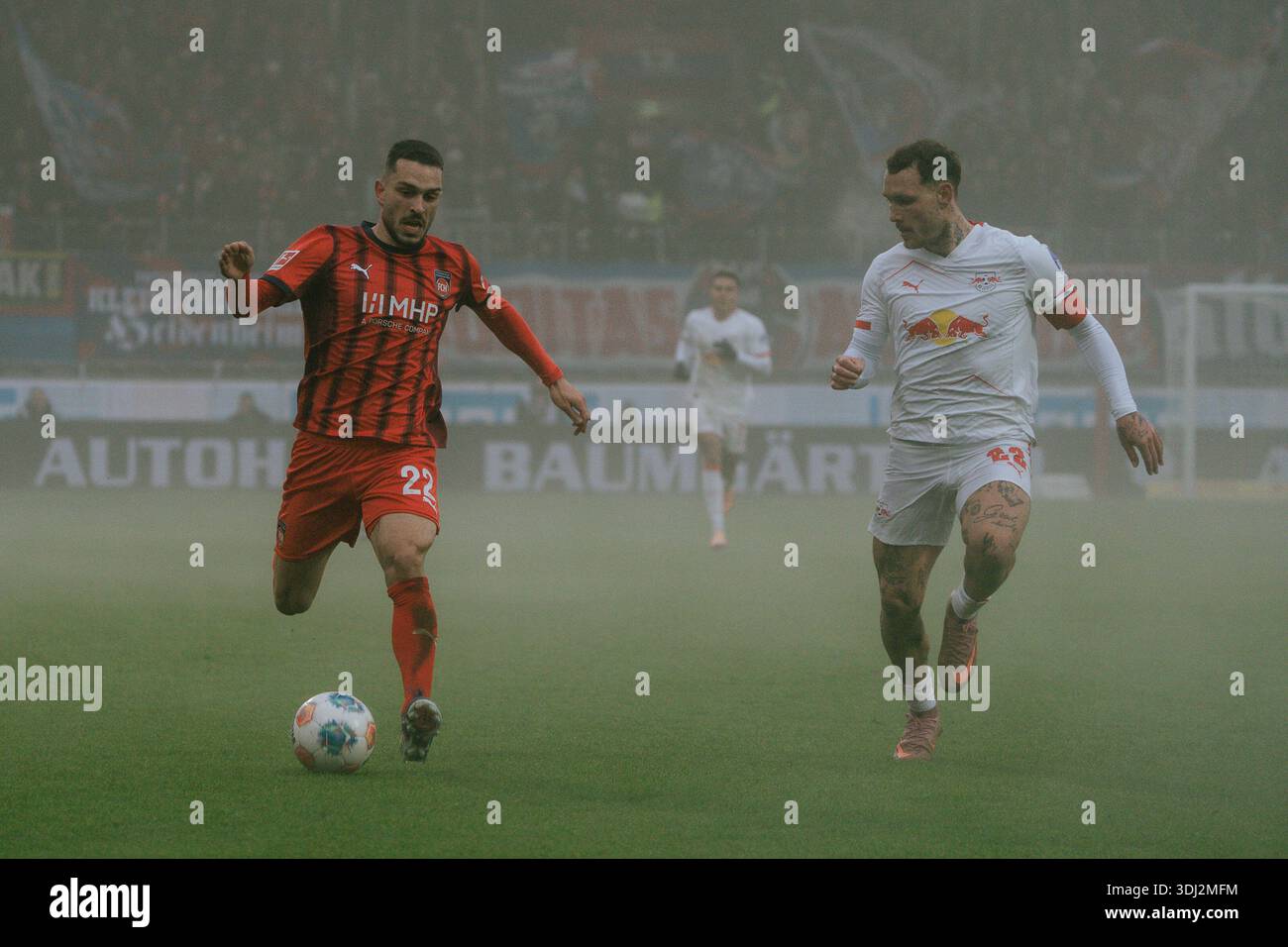 Tackle between Arijon Ibrahimovic (FC Heidenheim, #22) and David Raum ...