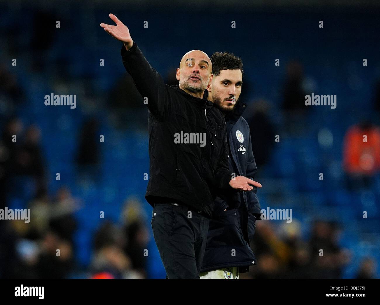 Manchester City manager Pep Guardiola and Rayan Cherki following the ...
