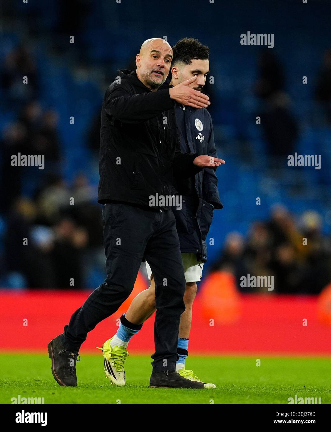 Manchester City manager Pep Guardiola and Rayan Cherki following the ...