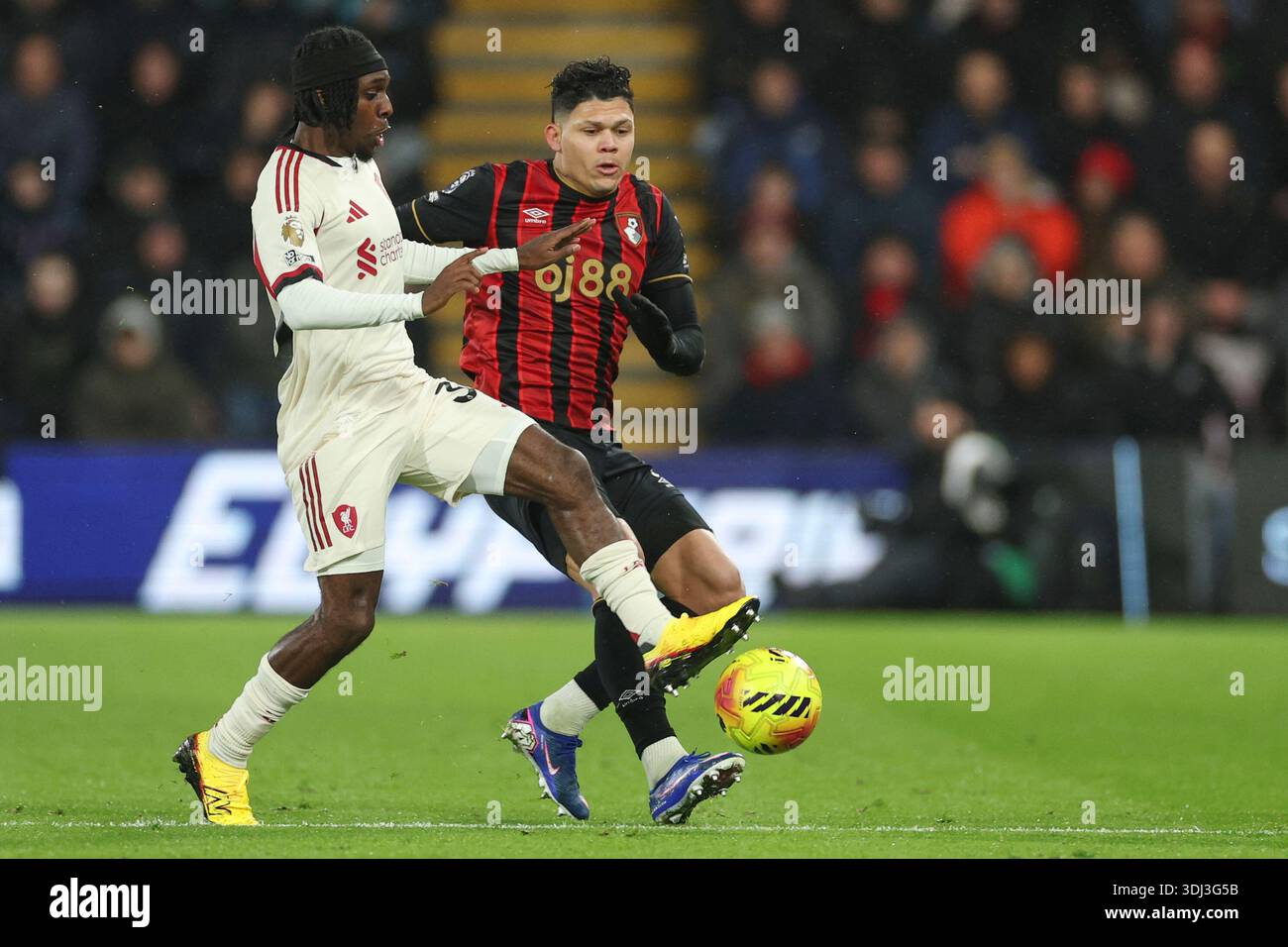 Liverpool's Jeremie Frimpong, left, vies for the ball with Bournemouth ...