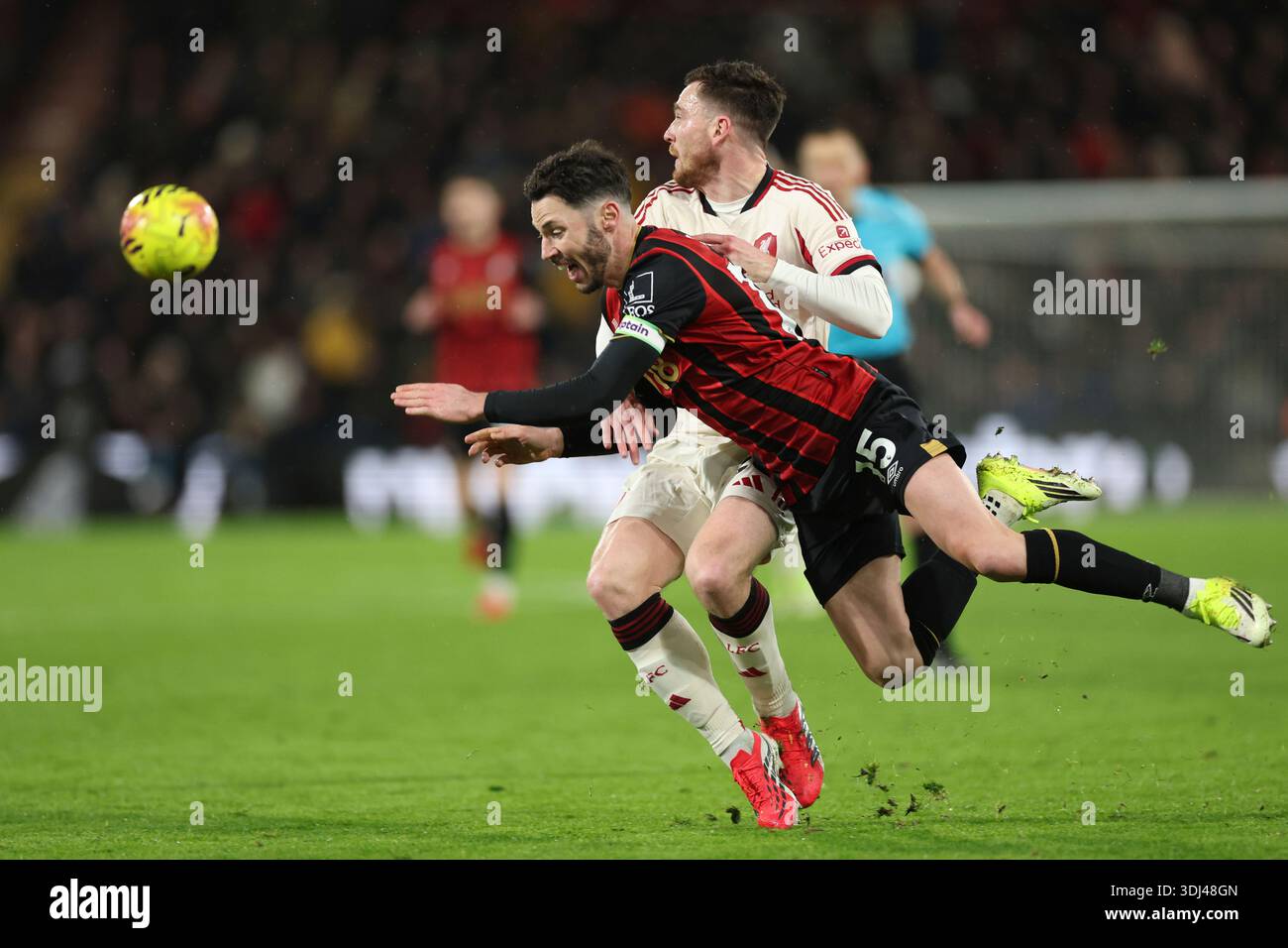 Bournemouth's Adam Smith, front falls in a tackle with Liverpool's Andy ...