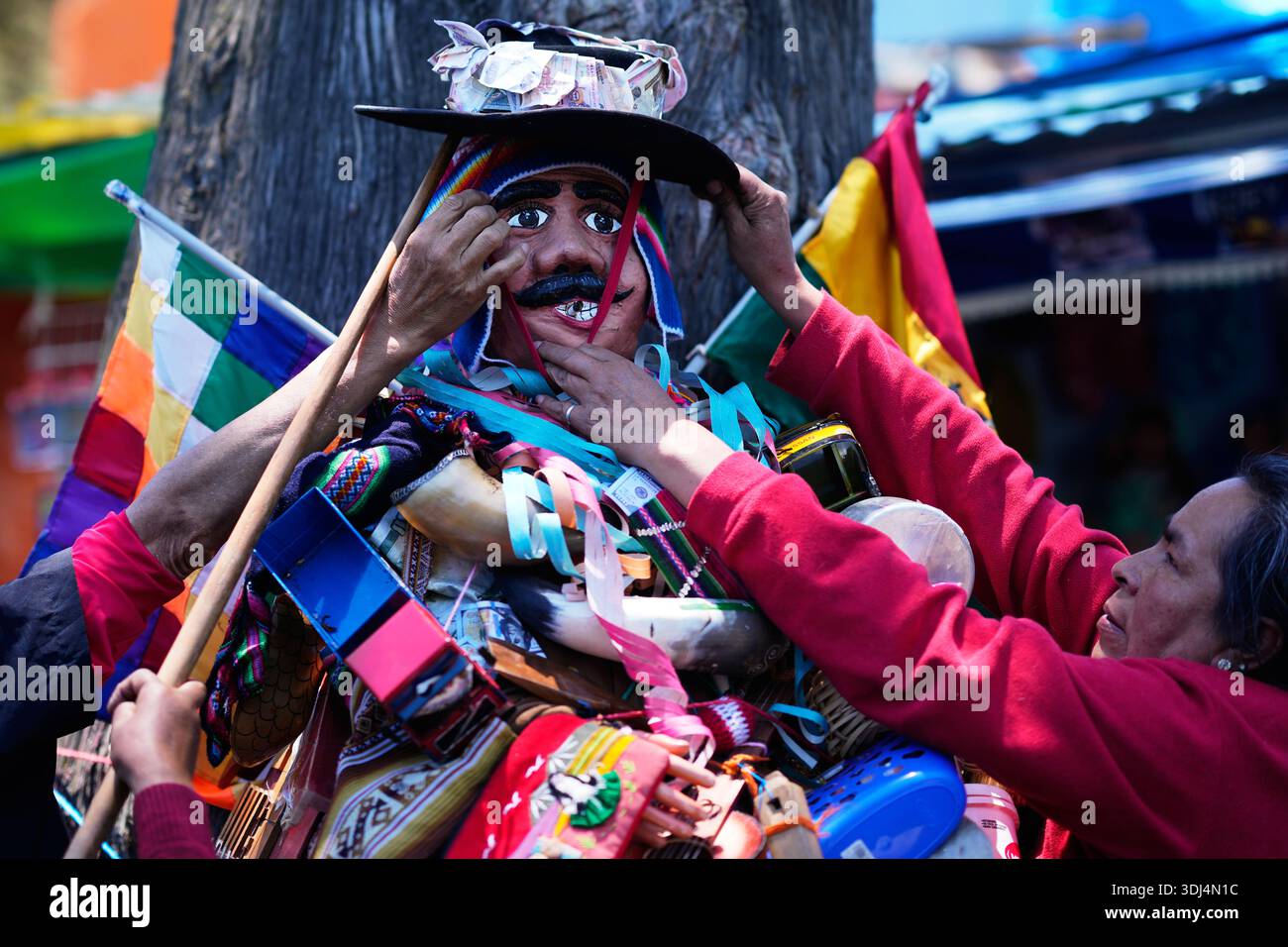 A person touches a statue of "Ekeko," the god of prosperity during an ...