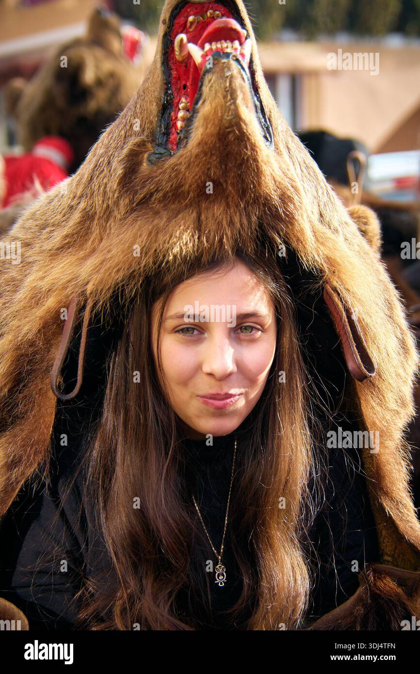 People dancing dressed in bearskin and folk costumes at the Comanesti ...