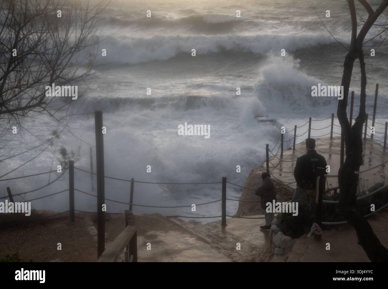 24 January 2026, Spain, Calvia: People look out over the choppy sea on ...