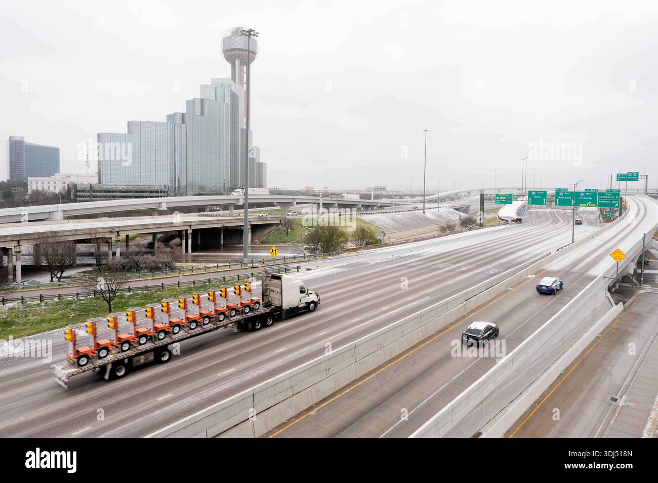 Drivers navigate icy and wet road conditions by the I35-I30 interchange ...