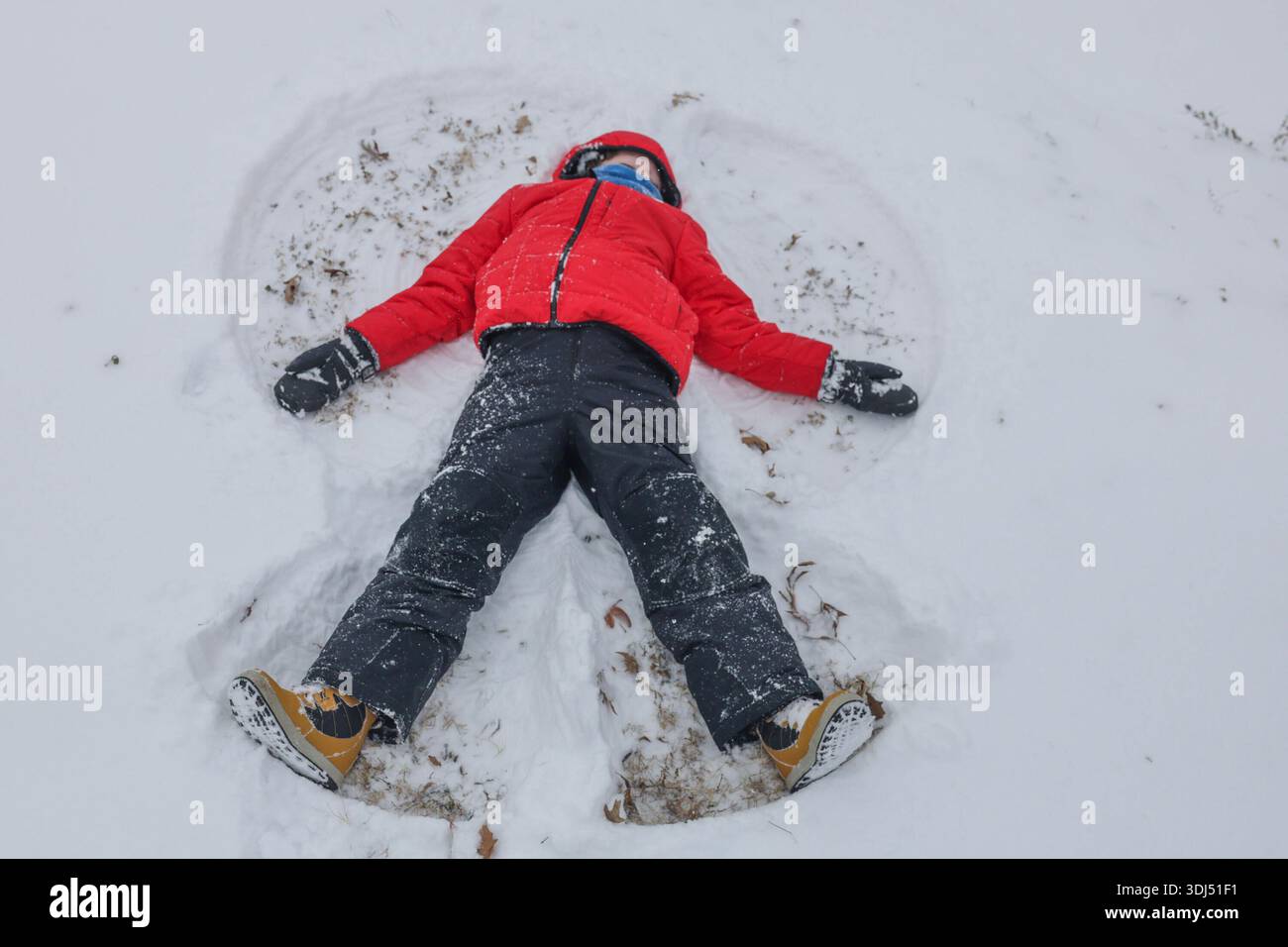 Juniper Tyler,7, makes a snow angel during a winter storm Saturday, Jan ...