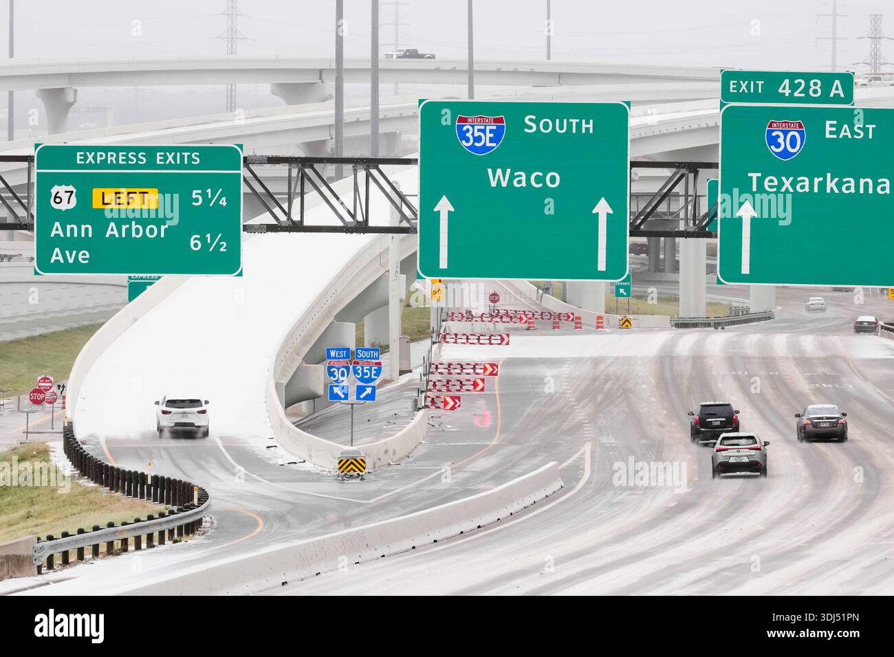 Drivers navigate icy and wet road conditions by the I35-I30 interchange ...