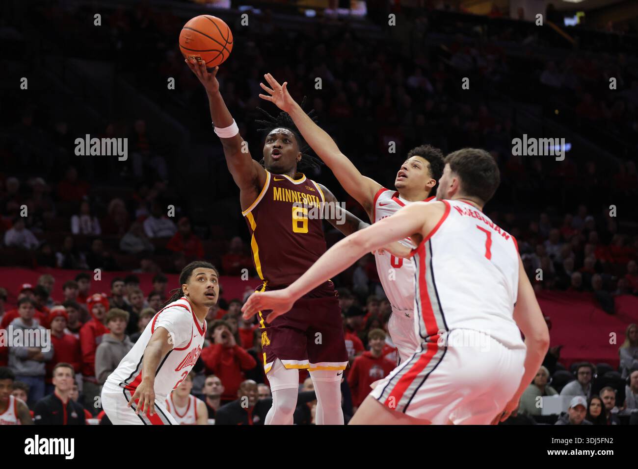 Minnesota guard Langston Reynolds (6) shoots between Ohio State forward ...