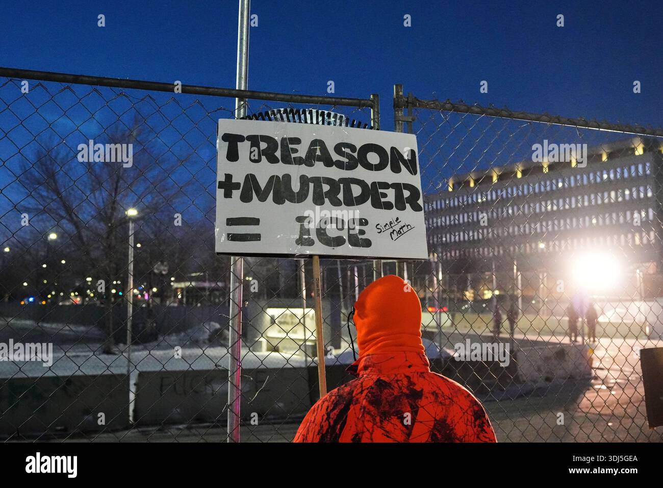 A protester holds a sign outside the Bishop Henry Whipple Federal ...
