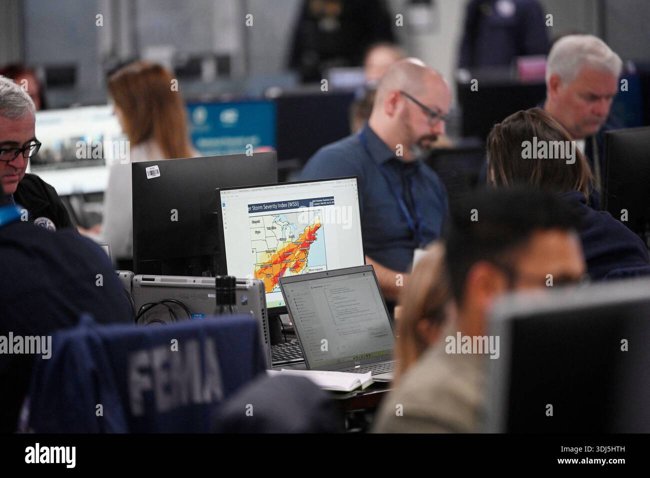 Employees work at the National Response Coordination Centerat at the ...
