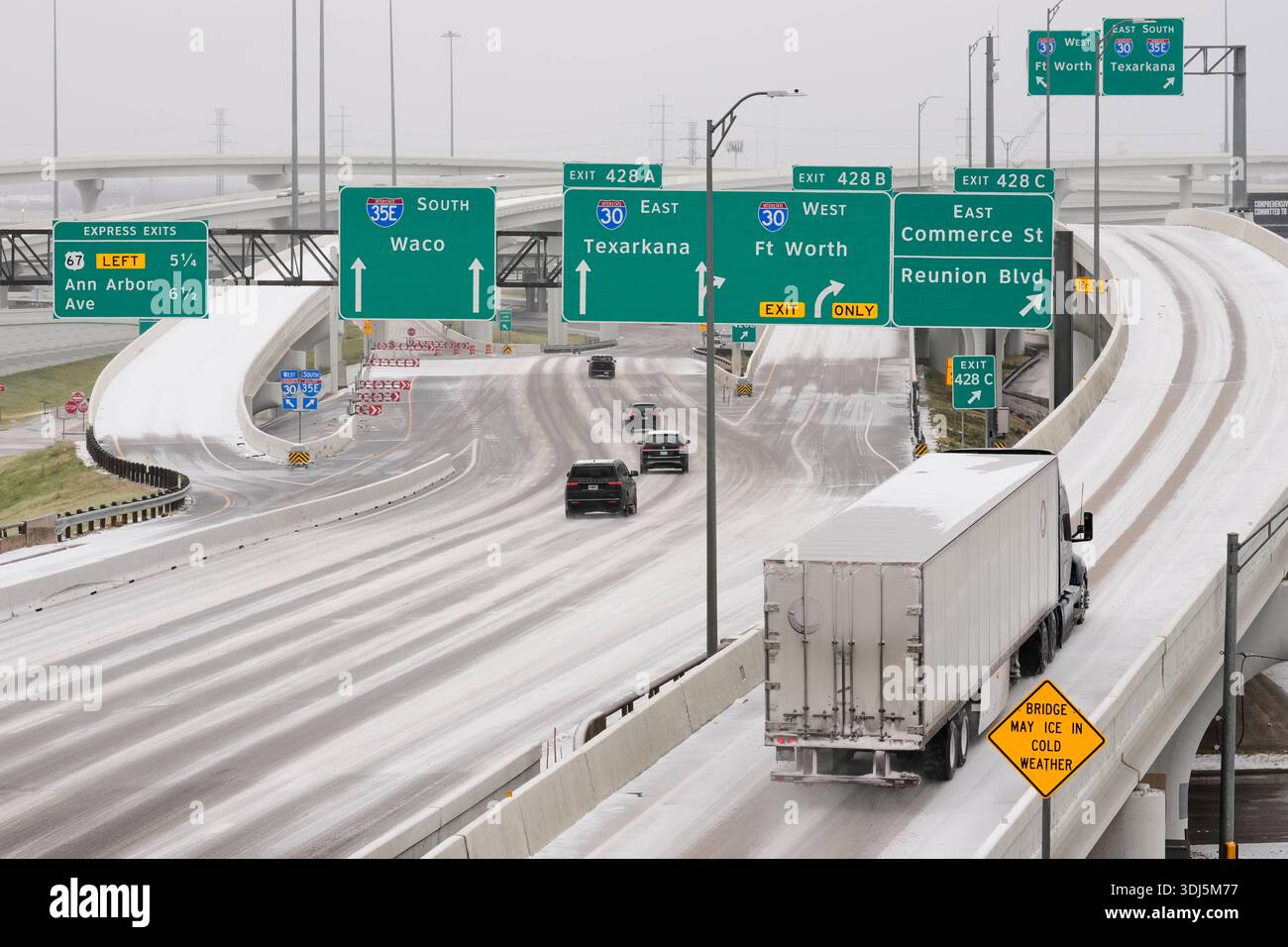 Drivers navigate icy and wet road conditions by the I35-I30 interchange ...
