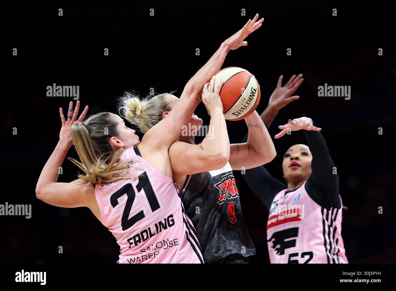Kiara Waite of the Lynx attempts to shoot under pressure from Keely ...
