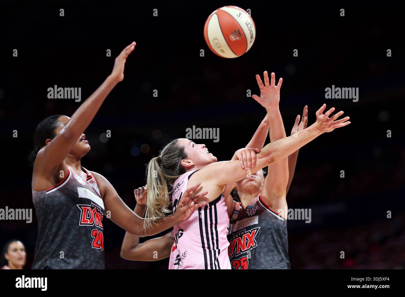 Keely Froling of the Flames competes for the ball with Yemiyah Morris ...