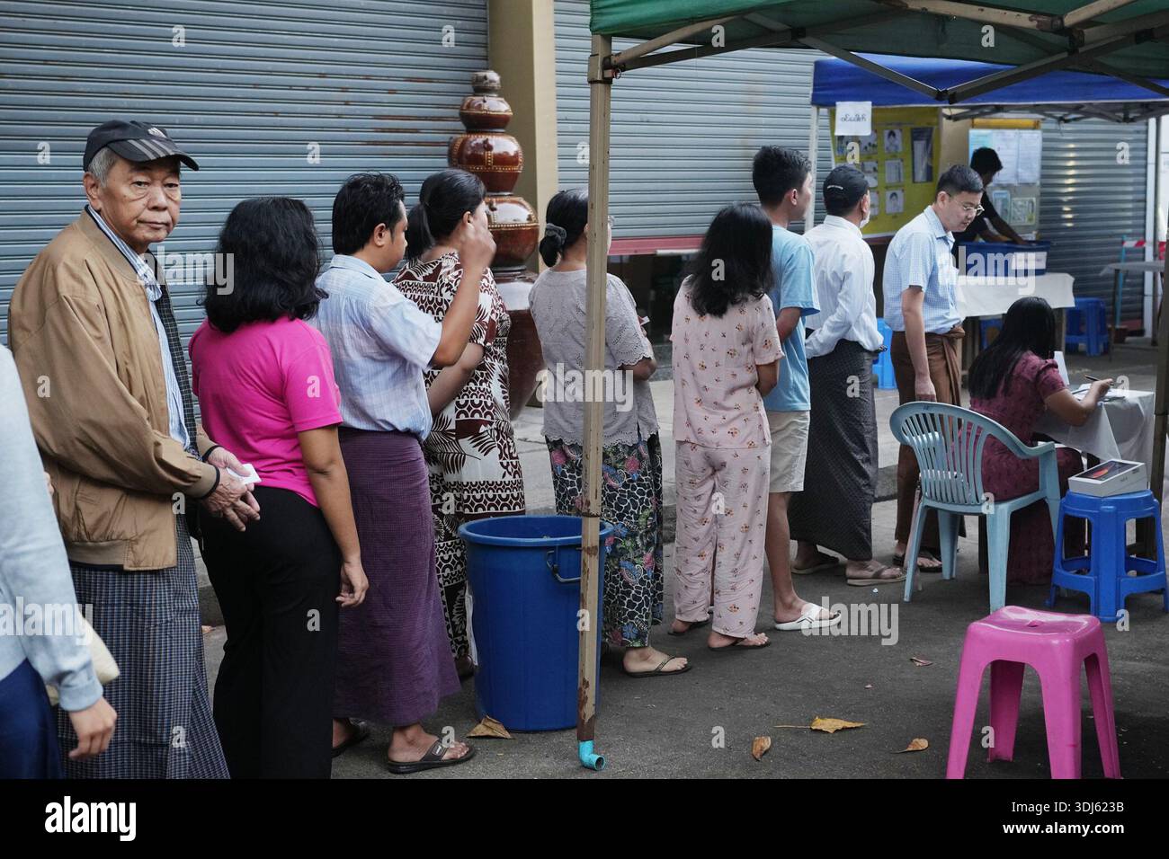 Voters line up to cast ballots at a polling station during the final ...