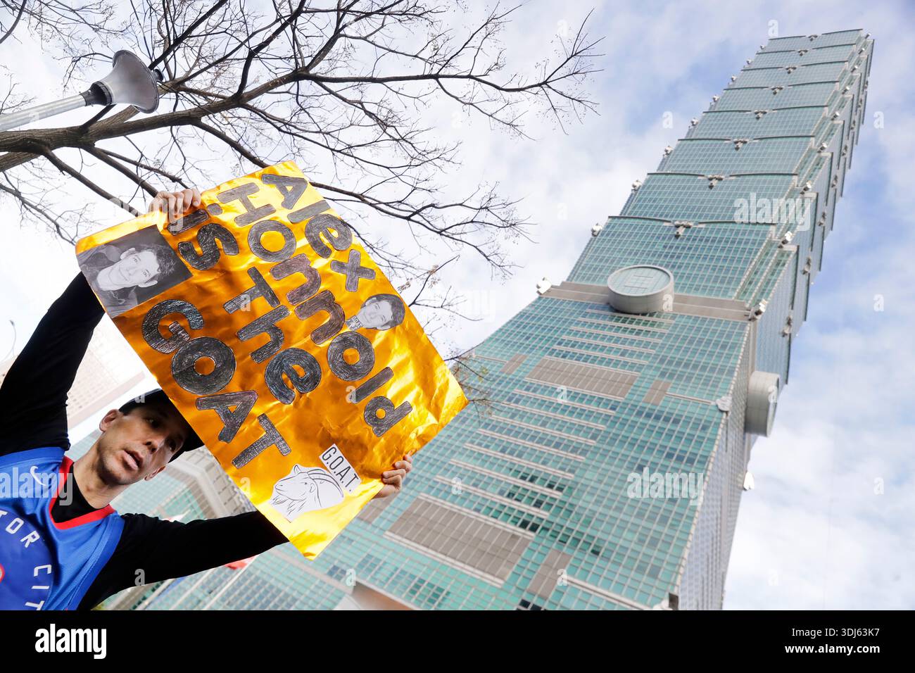 A fan of rock climber Alex Honnold, of the U.S., holds a poster before ...
