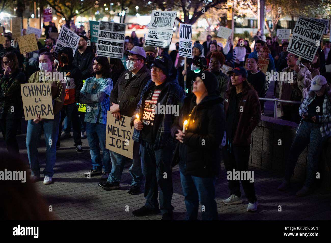 EDS NOTE: OBSCENITY - People hold signs and candles during a protest ...
