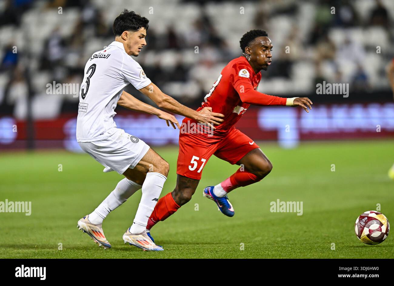 Doha, Qatar. 24th Jan, 2026. Younes Mohamed (L) of Al Sadd FC and Yuri ...