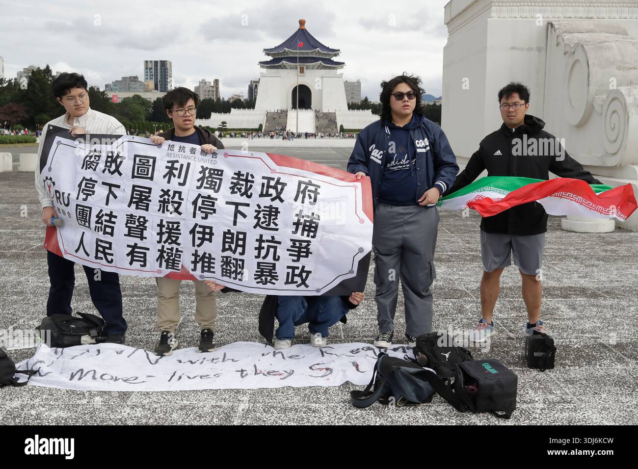 Supporters of the Iranian people hold an Iranian flag and banner during ...
