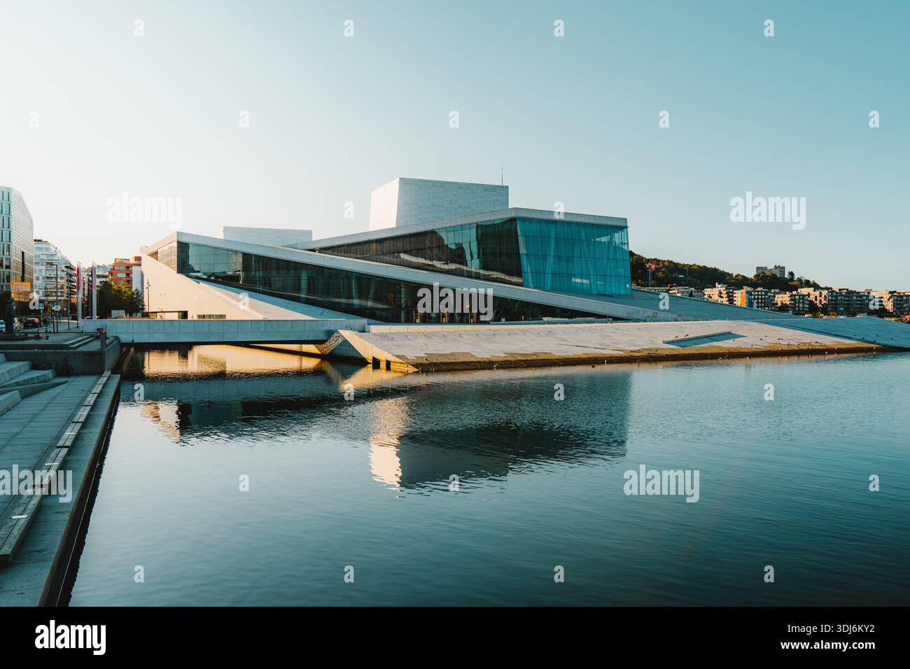 The Oslo Opera House (Operahuset) reflected in the water at sunrise ...