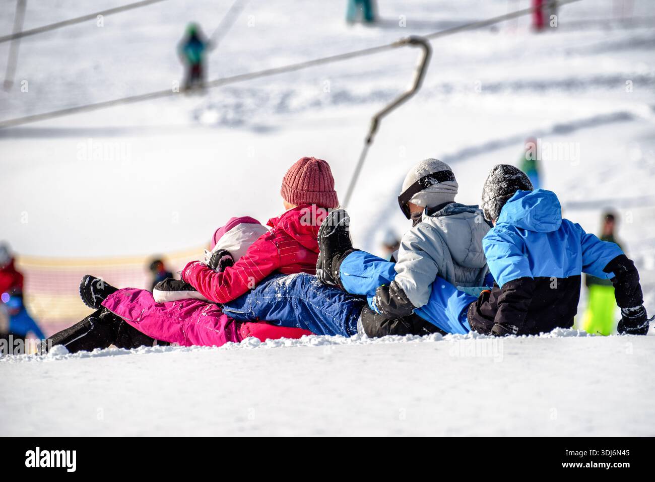 Happy children enjoying winter fun on snowy slope at ski resort ...