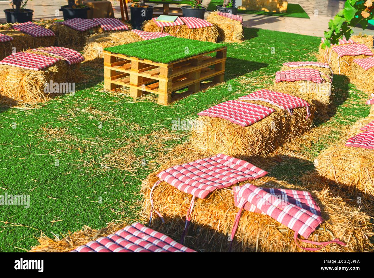 Outdoor event space with seating made from hay bales topped with ...