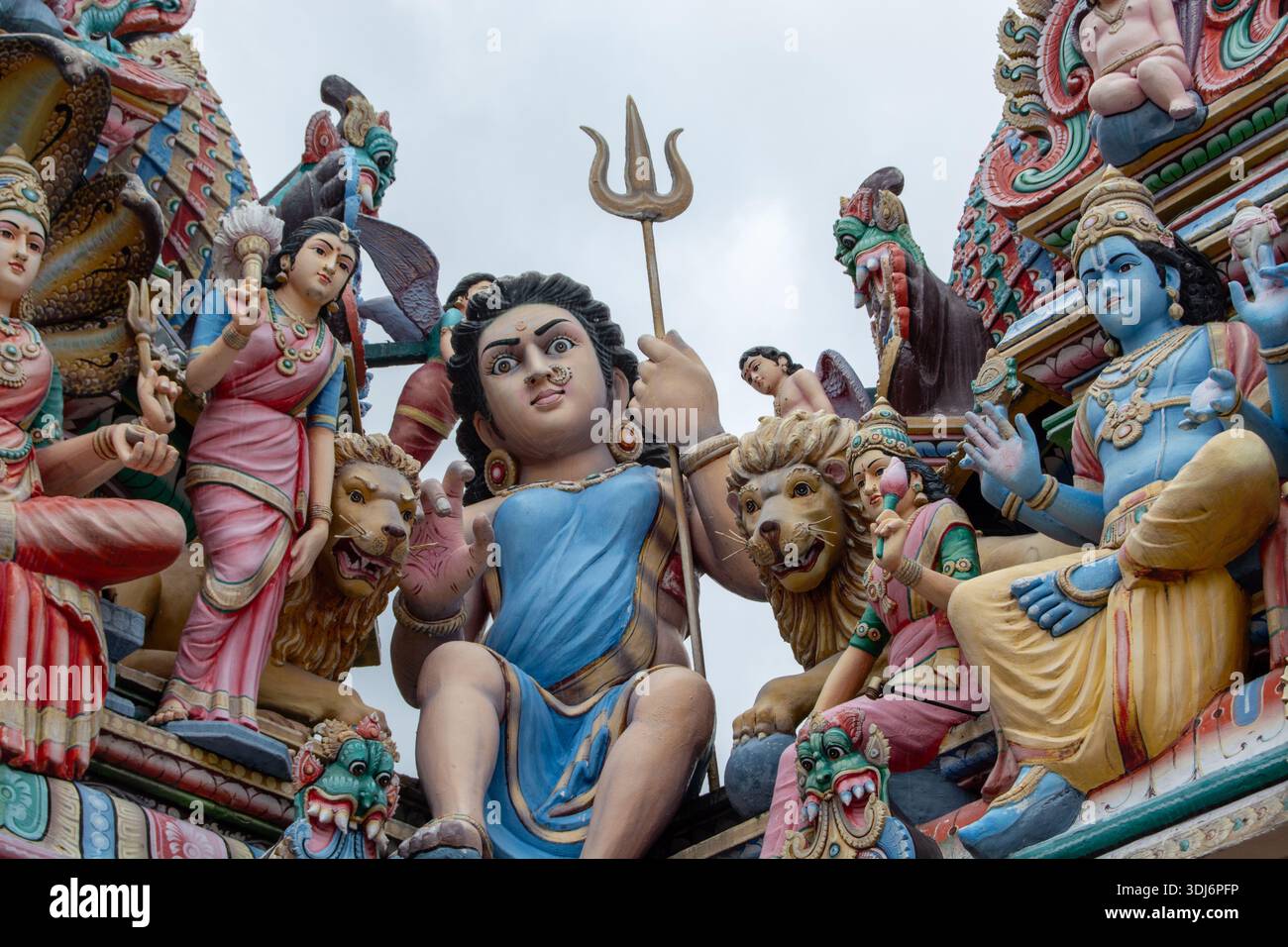 A colorful temple sculpture featuring deities and mythical creatures ...