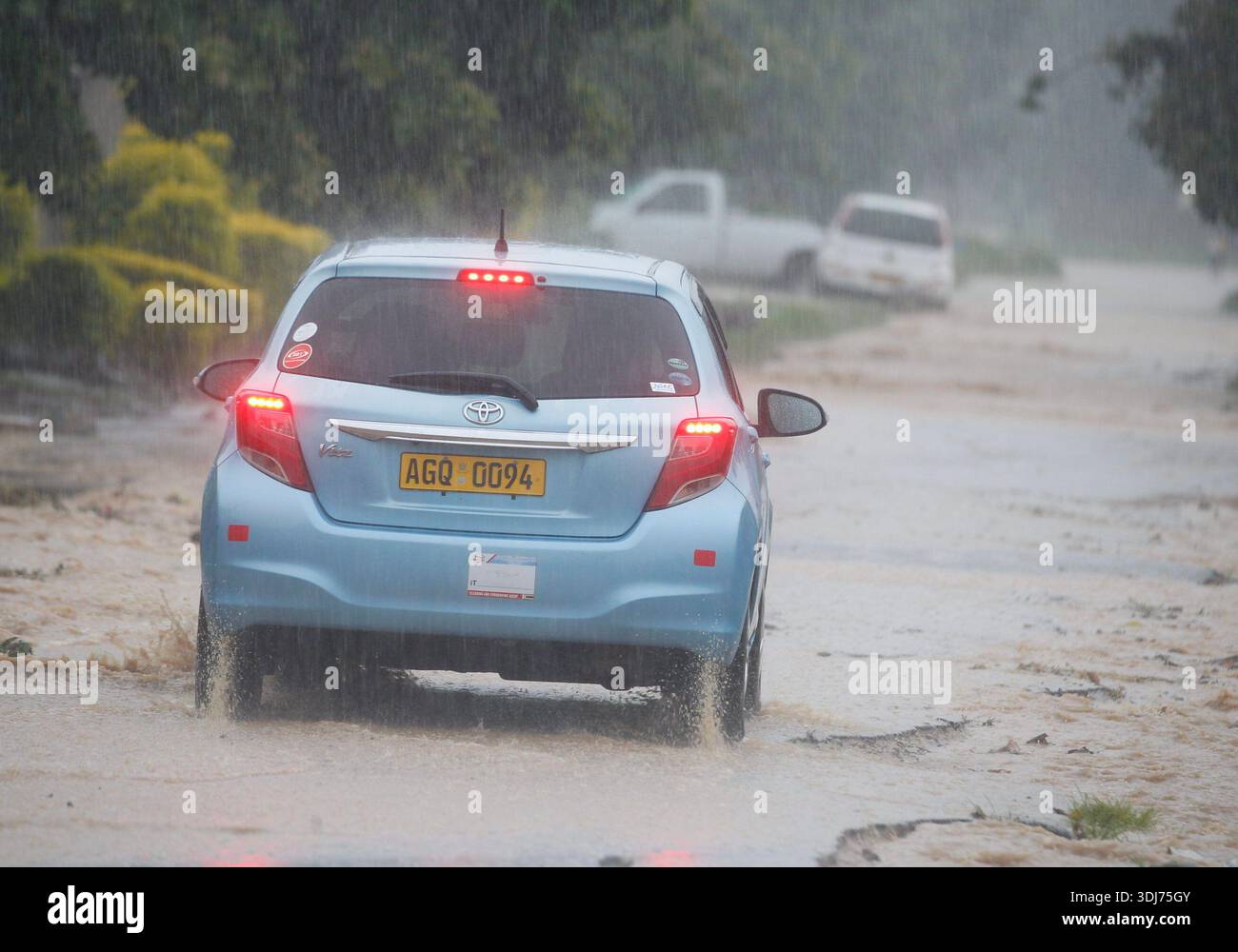 Harare, Zimbabwe. 24th Jan, 2026. A car drives in heavy rain in Harare ...