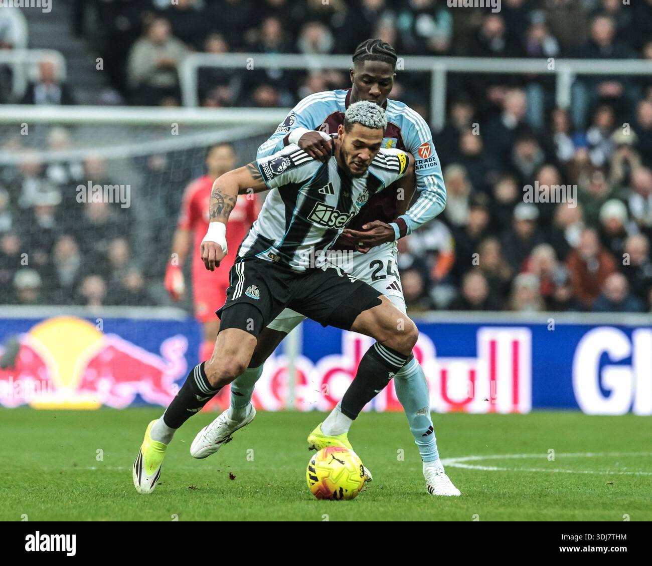 Joelinton of Newcastle United holds off Amadou Onana of Aston Villa ...