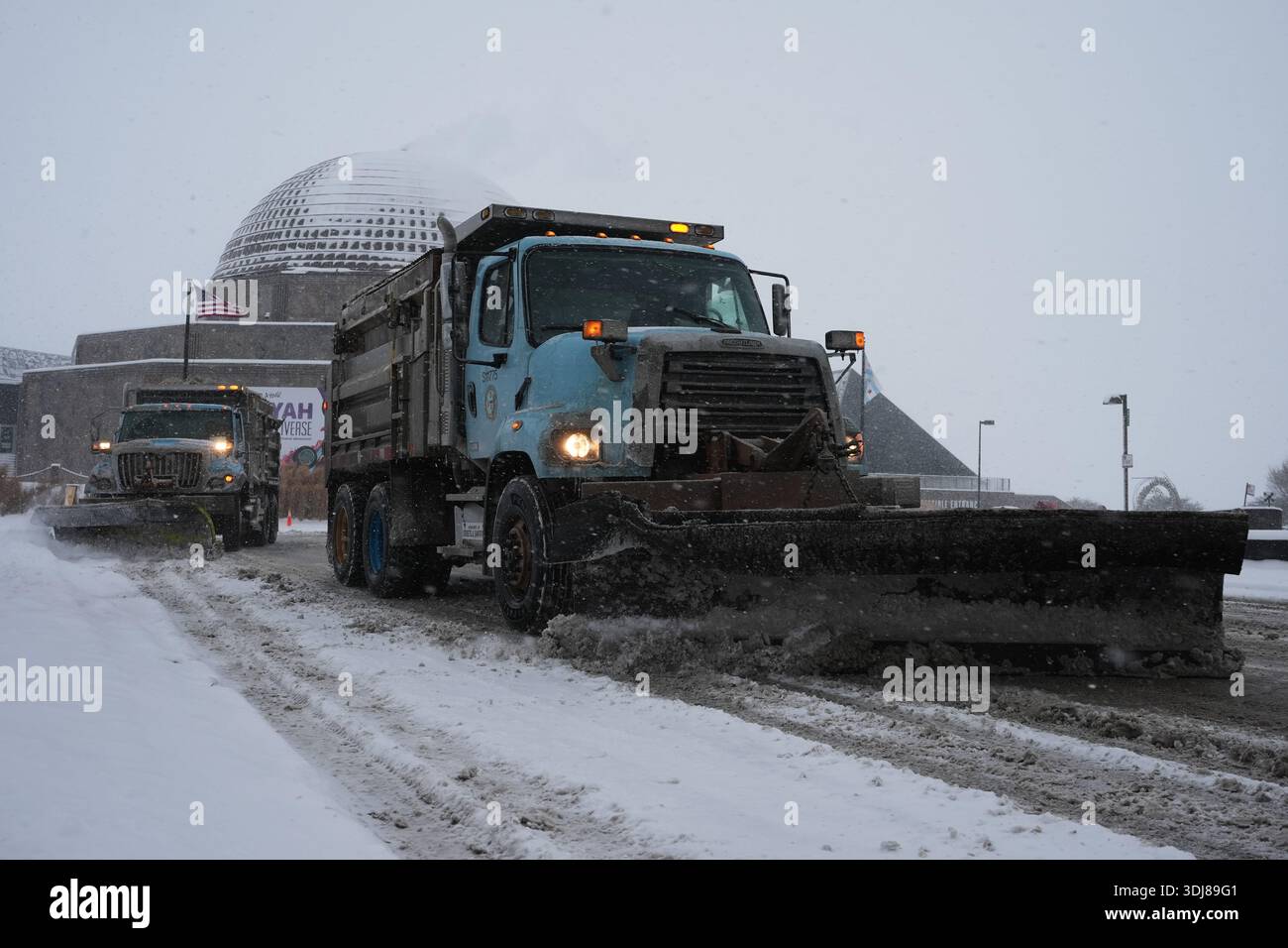 Snow plows clean snow in front of Adler Planetarium in Chicago, Sunday ...