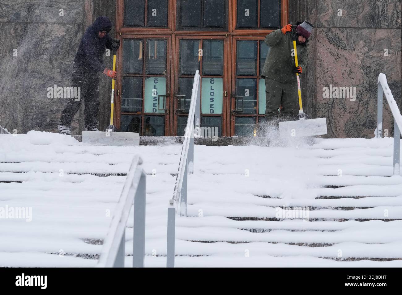 People clear snow in front of Adler Planetarium in Chicago, Sunday, Jan ...