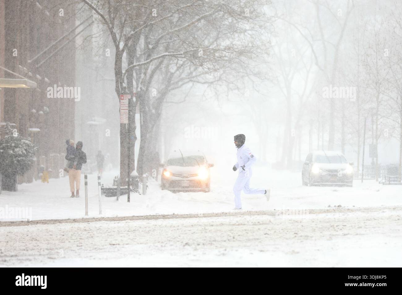 Pedestrians cross the street during a winter storm, Sunday, Jan. 25 ...