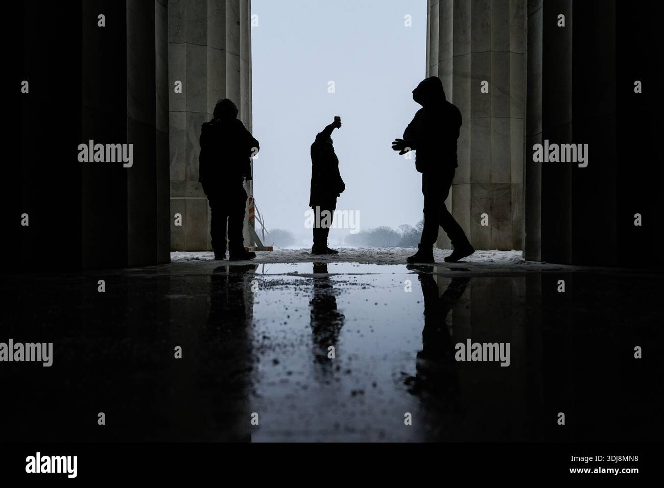 Robert Allen, center, takes a photo at the Lincoln Memorial as snow ...