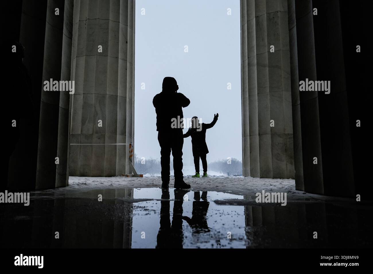 Robert Allen, right, takes a photo at the Lincoln Memorial as snow ...