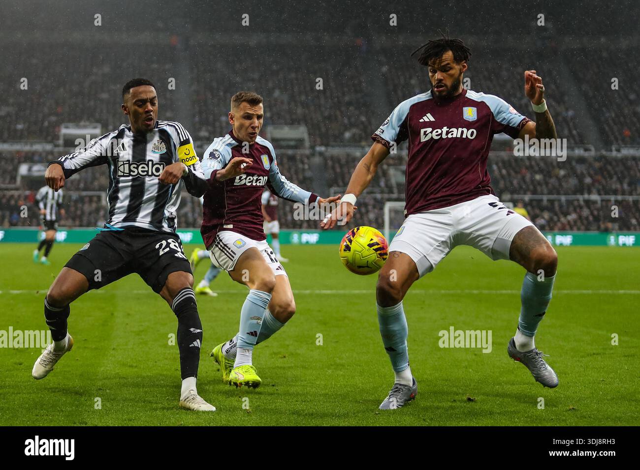 Joe Willock Of Newcastle United battles with Tyrone Mings Of Aston ...