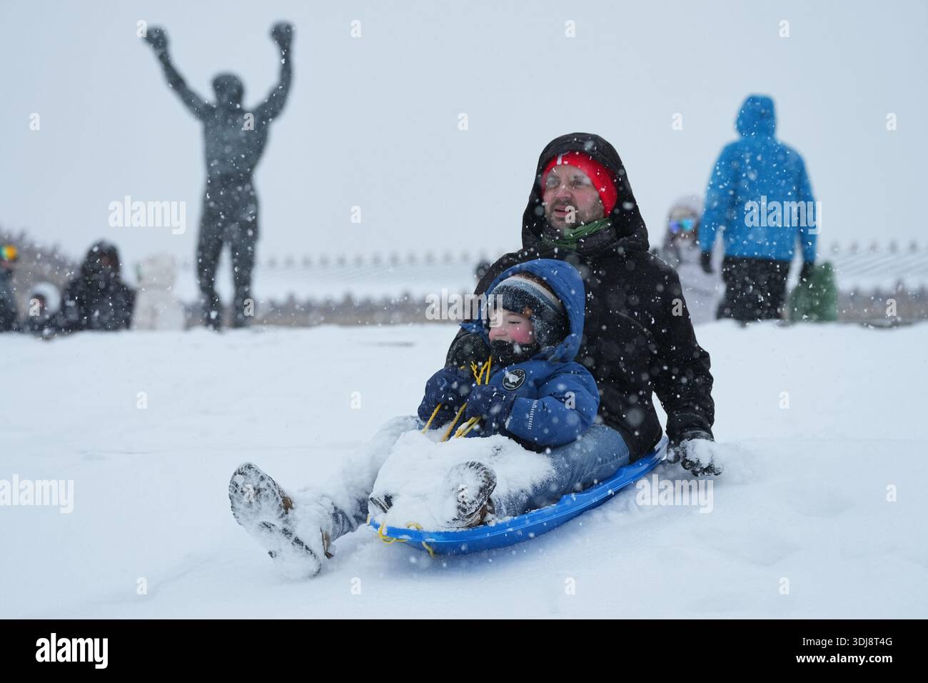 People sled at Philadelphia Art Museum steps by the Rocky statue during ...