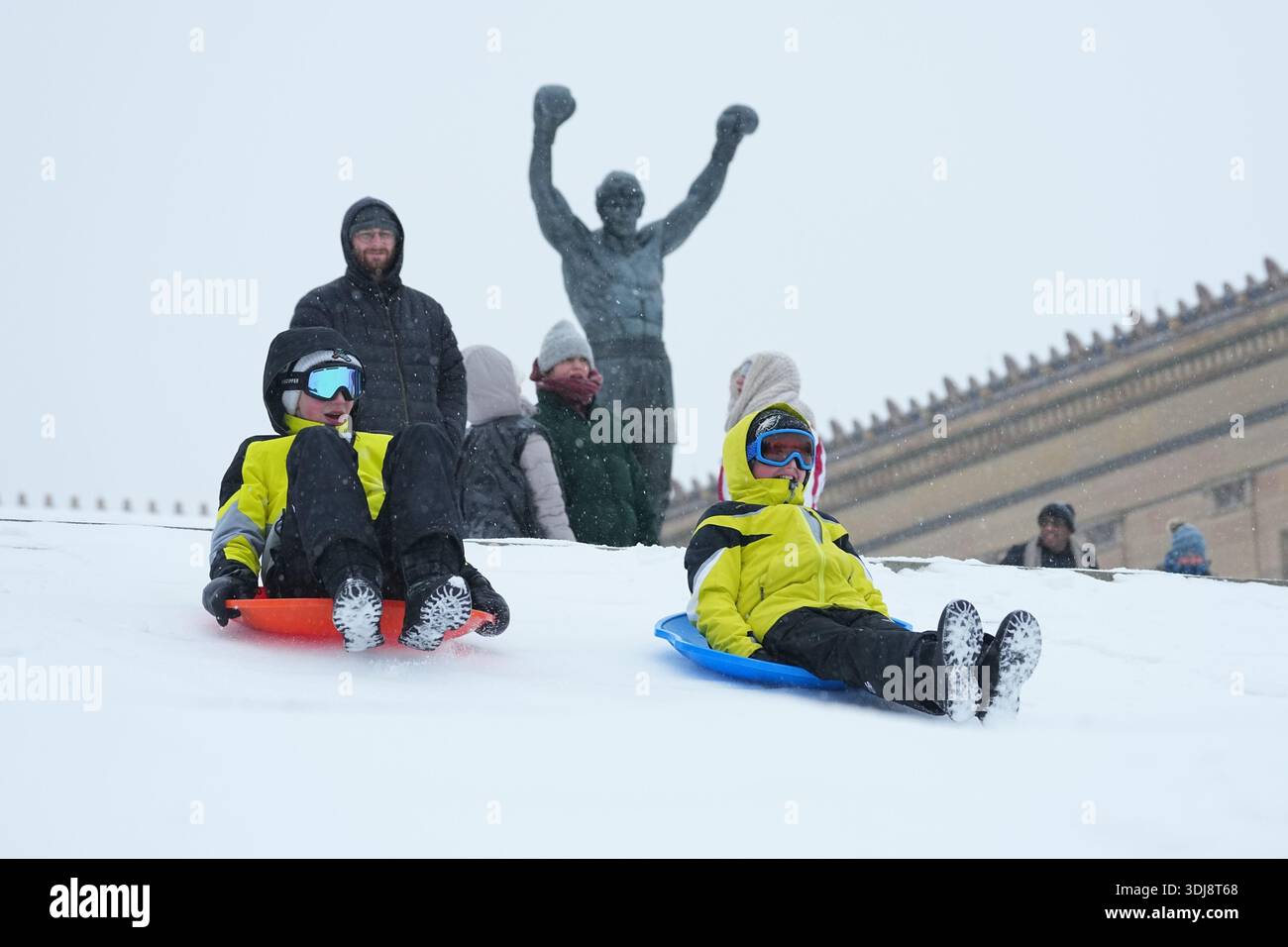 People sled at Philadelphia Art Museum steps by the Rocky statue during ...