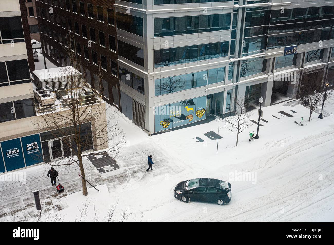 A car is stranded during a snowstorm, Sunday, Jan. 25, 2026, in ...