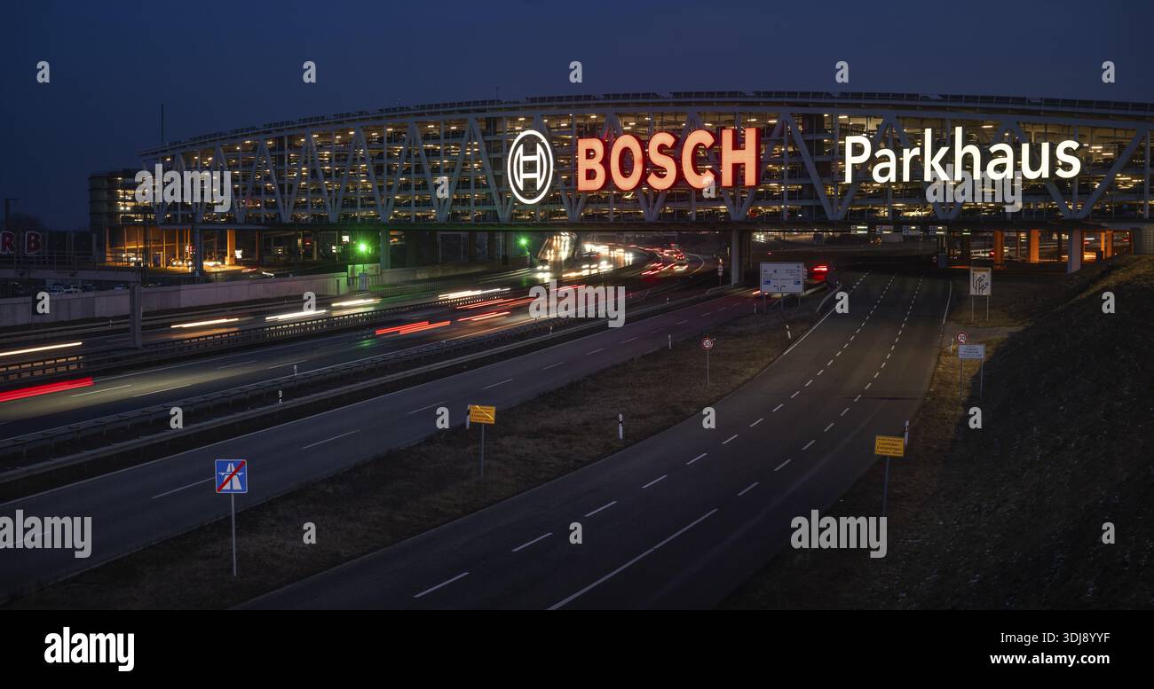 Traffic on the A8 motorway, blue hour, illuminated parking garage ...