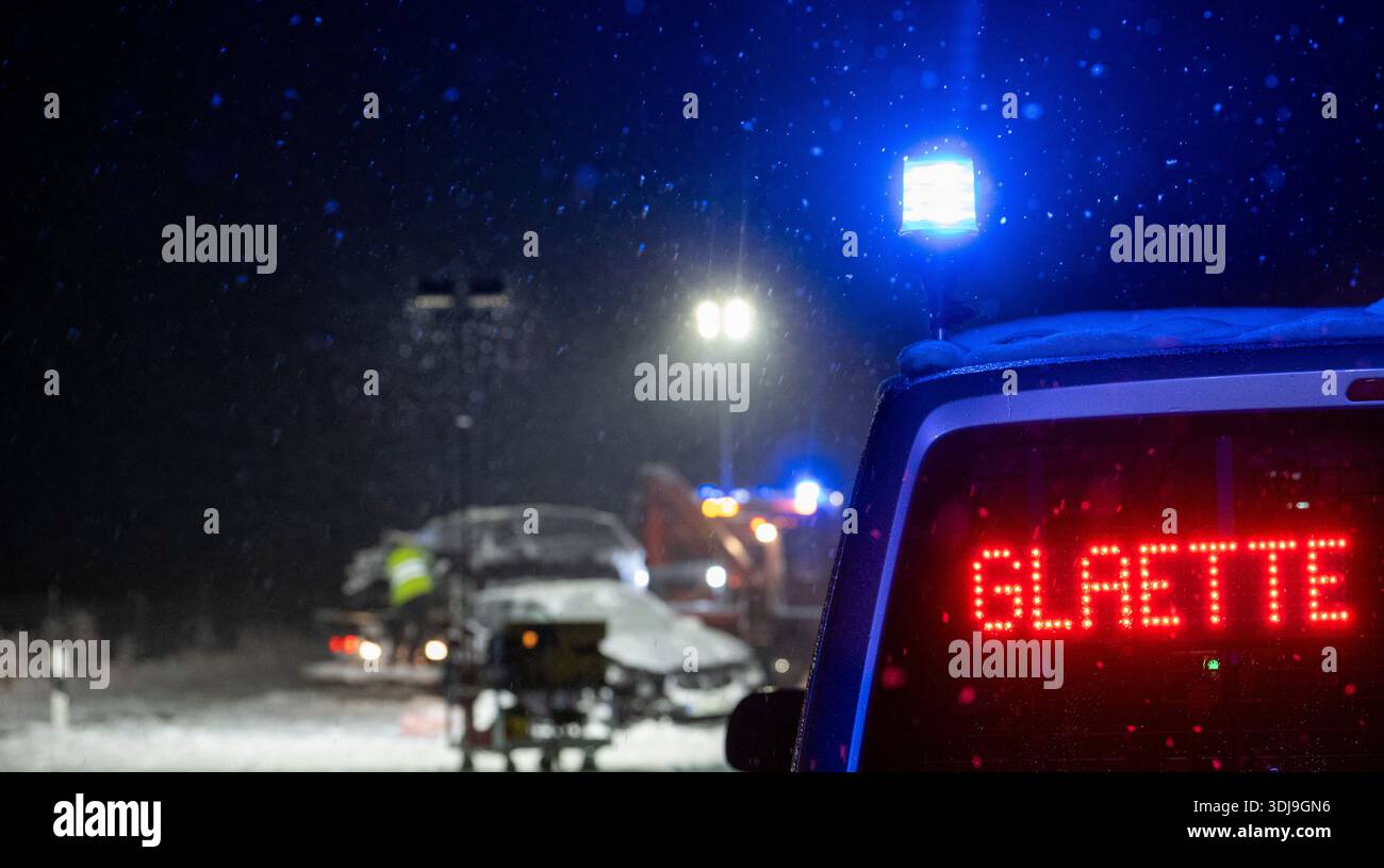 25 January 2026, Bavaria, Germaringen: A police vehicle warns of icy ...