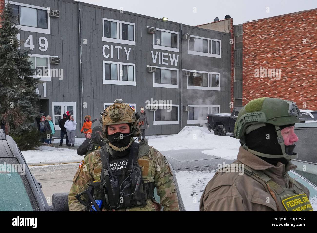 Federal agents are seen at City View Apartments in Minneapolis, Sunday ...