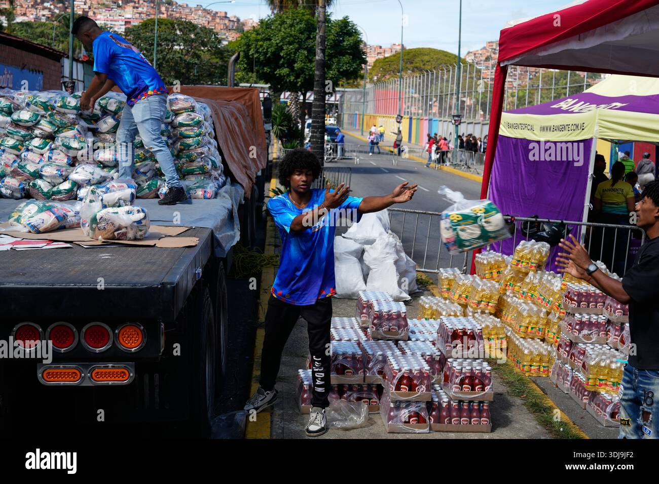 Workers unload bags of food at a government-subsidized market in ...