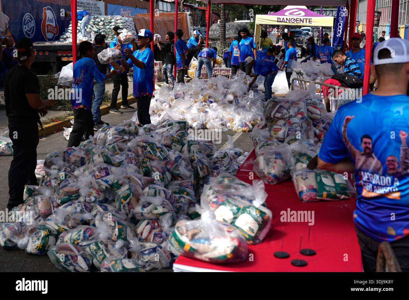 Workers unload bags of food at a government-subsidized market in ...