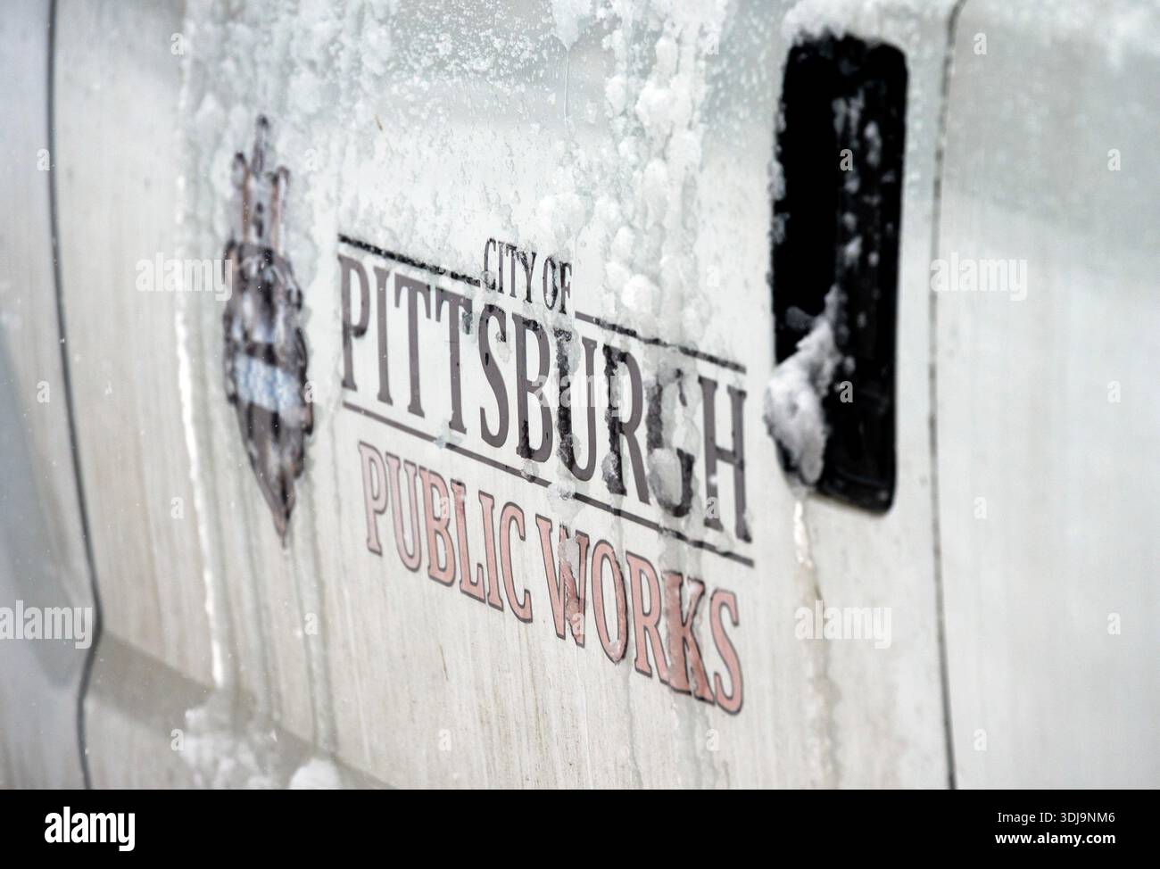 Ice and snow collects on the door ion a City of Pittsburgh Public Work ...