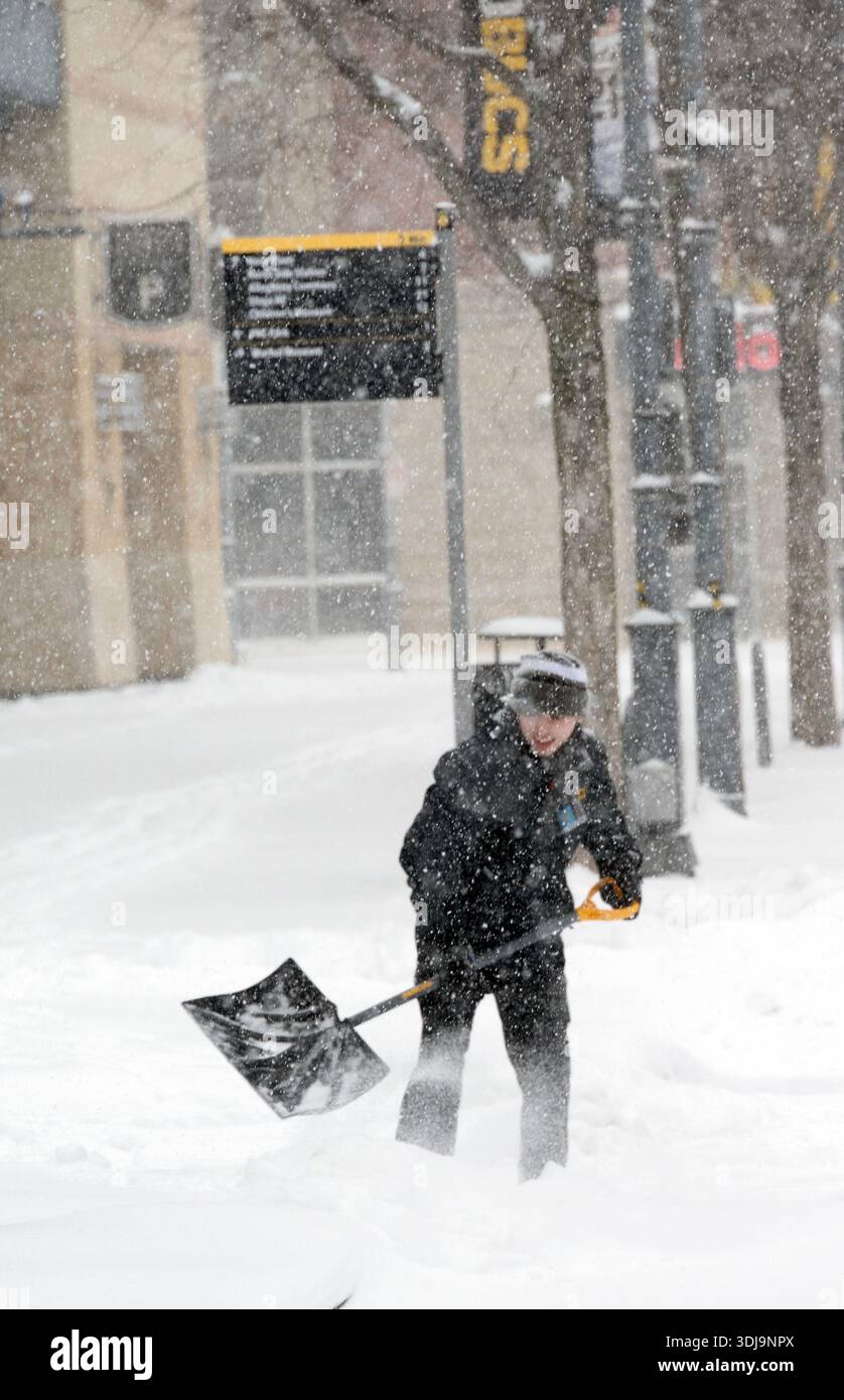 A worker shovels snow at PNC Park during the snow storm in Pittsburgh ...