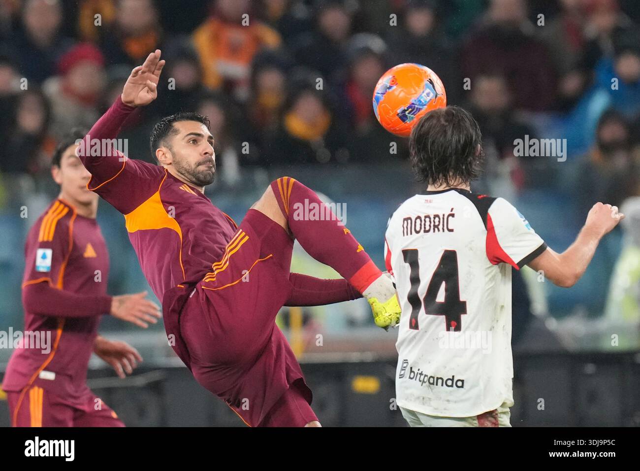 Roma's Zeki Celik, centre, and AC Milan's Luka Modric challenge for the ...