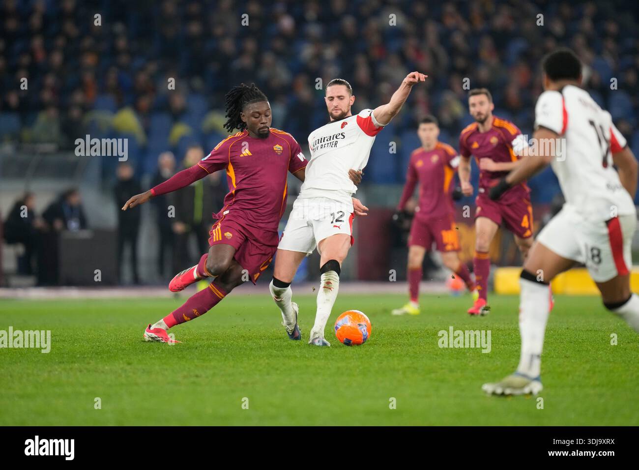 Roma's Manu Kone, left, and AC Milan's Adrien Rabiot challenge for the ...