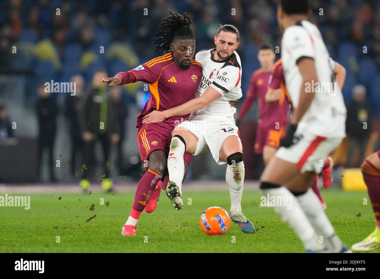 Roma's Manu Kone, left, and AC Milan's Adrien Rabiot challenge for the ...